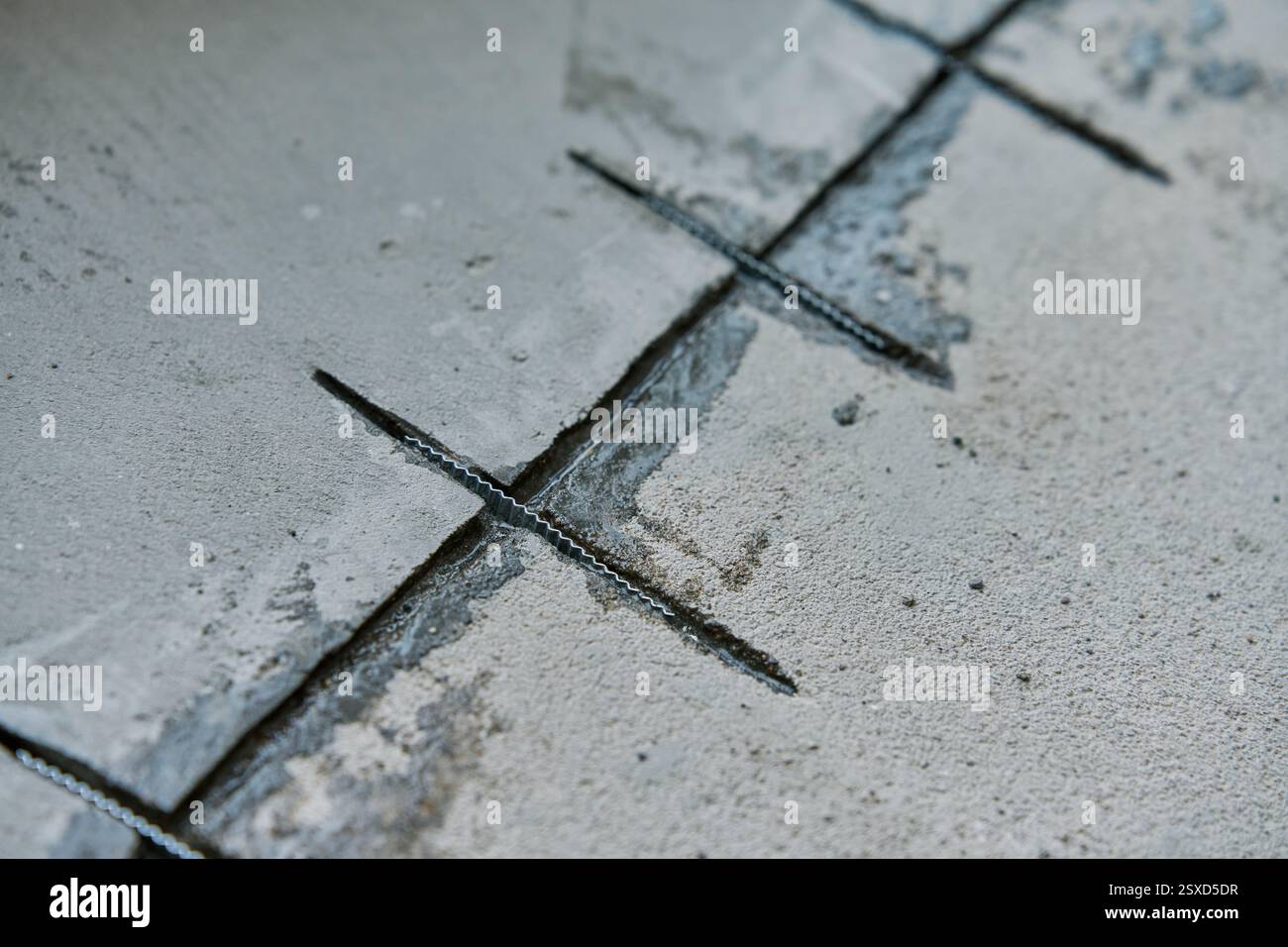 Close-up of concrete surface under repair with reinforcement bars ...