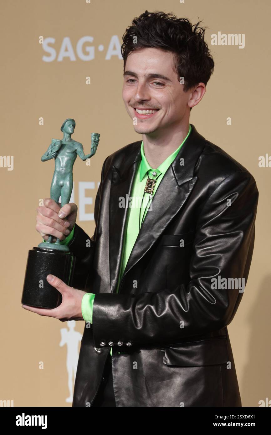 Timothée Chalamet poses in the press room with the award for ...