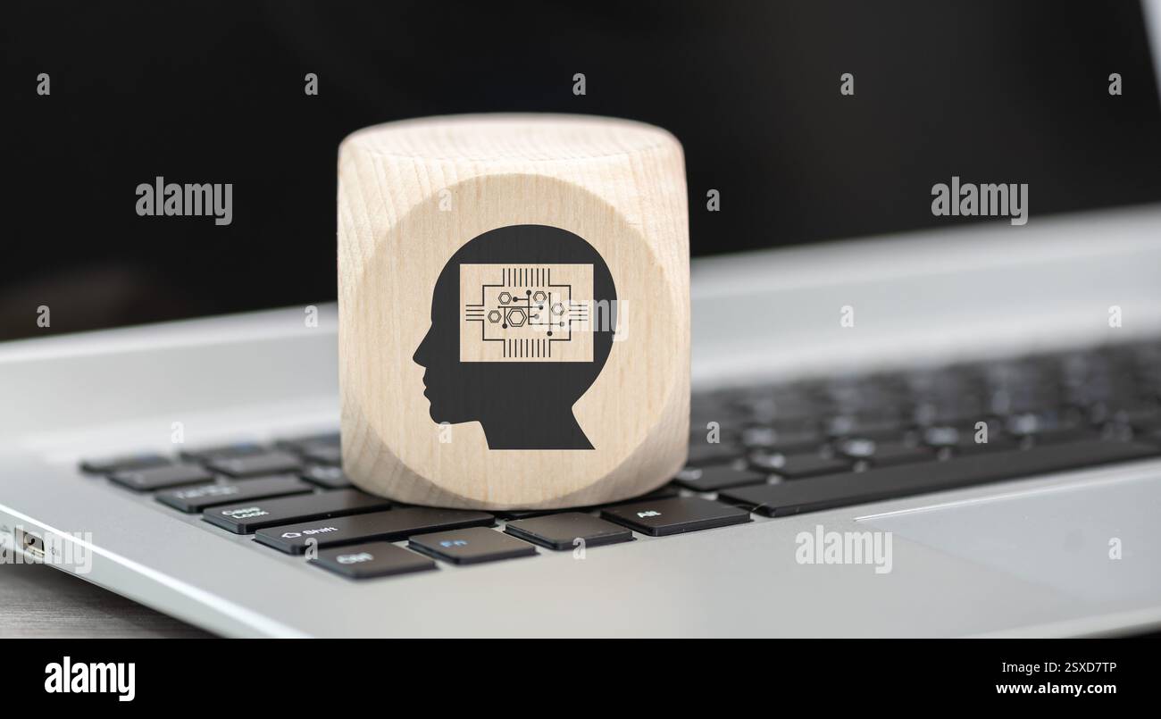 Wooden block with symbol of machine learning concept on laptop keyboard ...