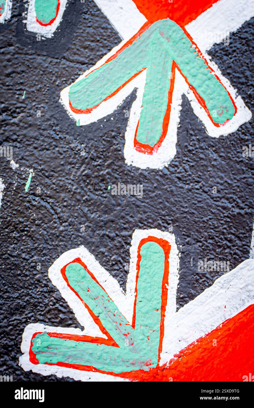 A wall with bright arrows pointing in different directions. Abstract ...