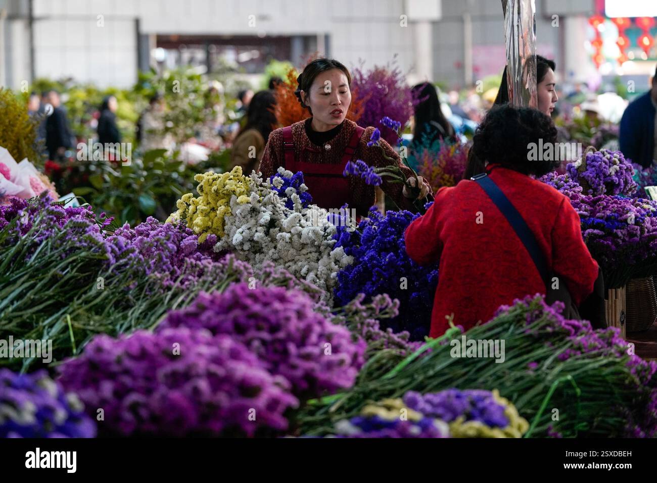 People select flowers at a flower market in Kunming City, southwest ...