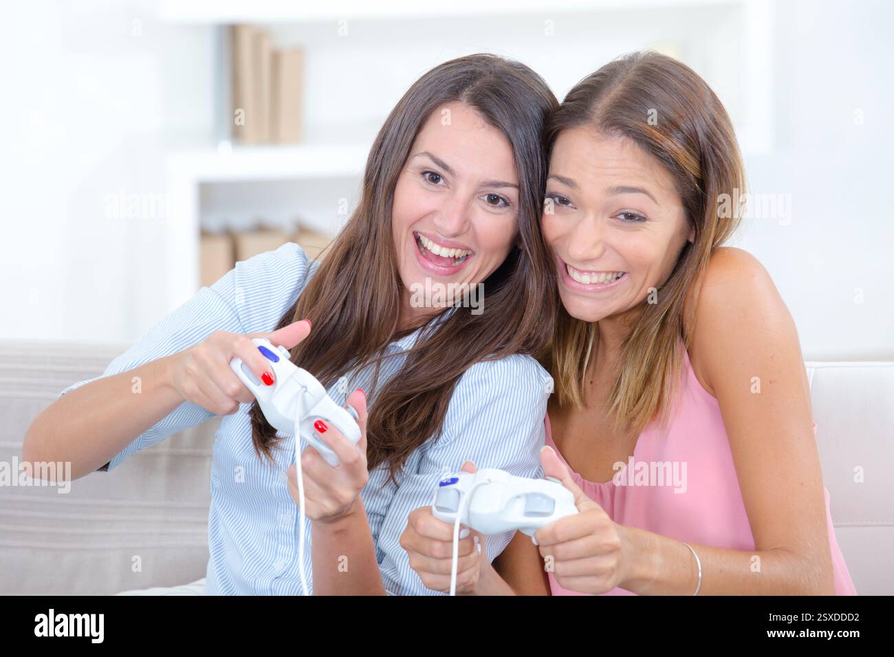 Two ladies playing computer game Stock Photo - Alamy