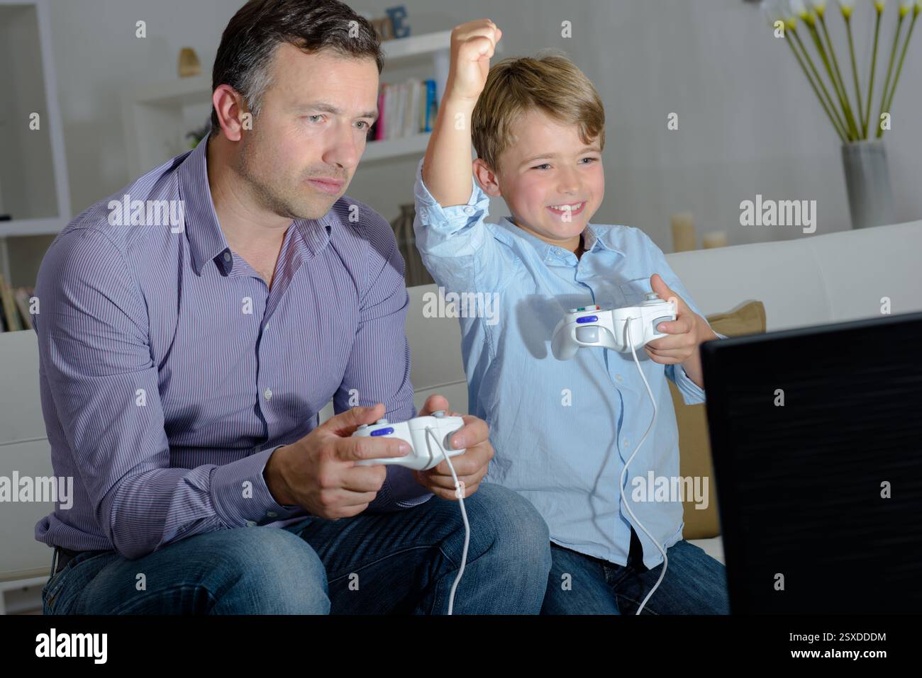 Child beating adult on computer game Stock Photo - Alamy