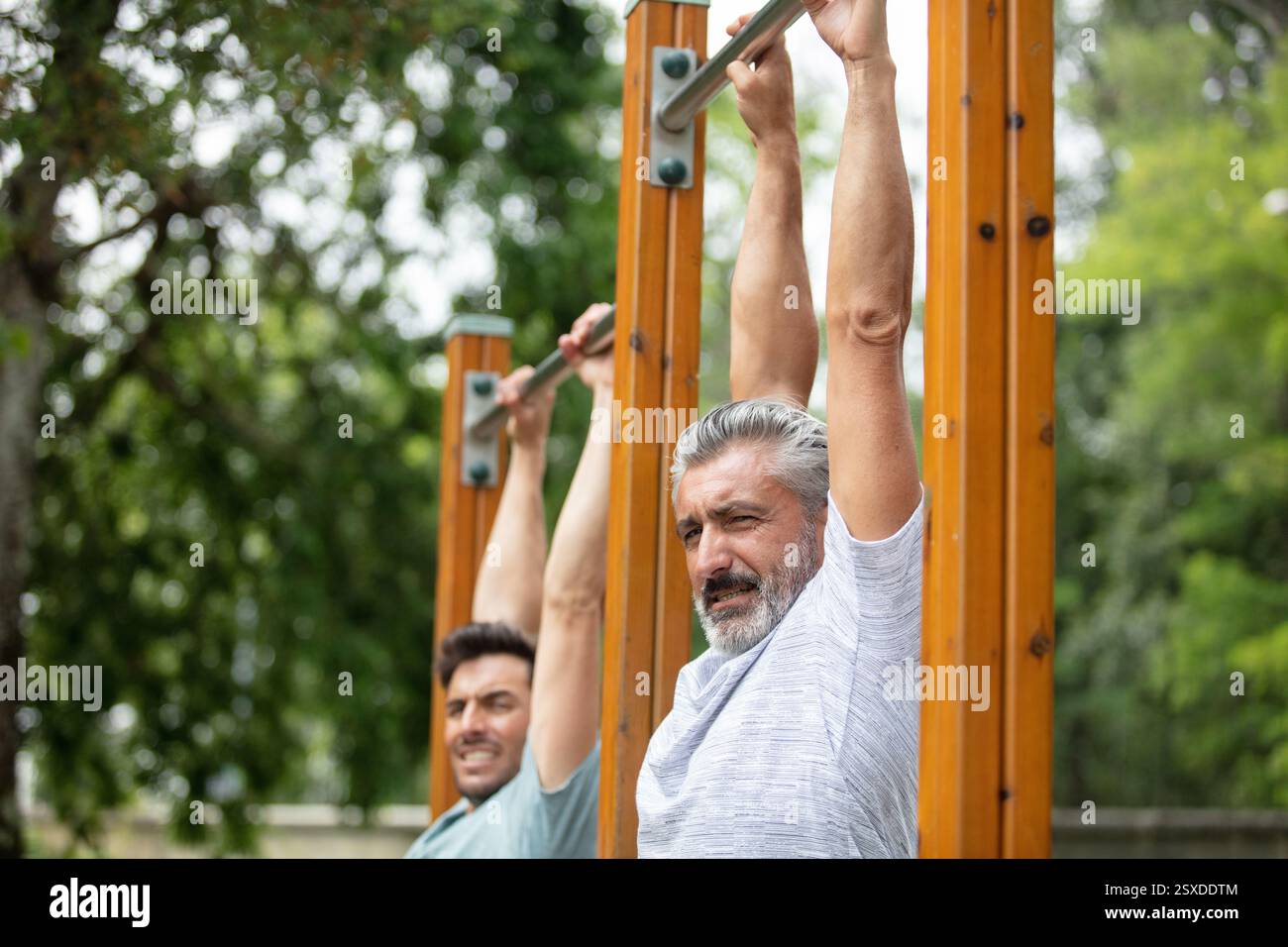 athletic men doing parallel bars Stock Photo - Alamy