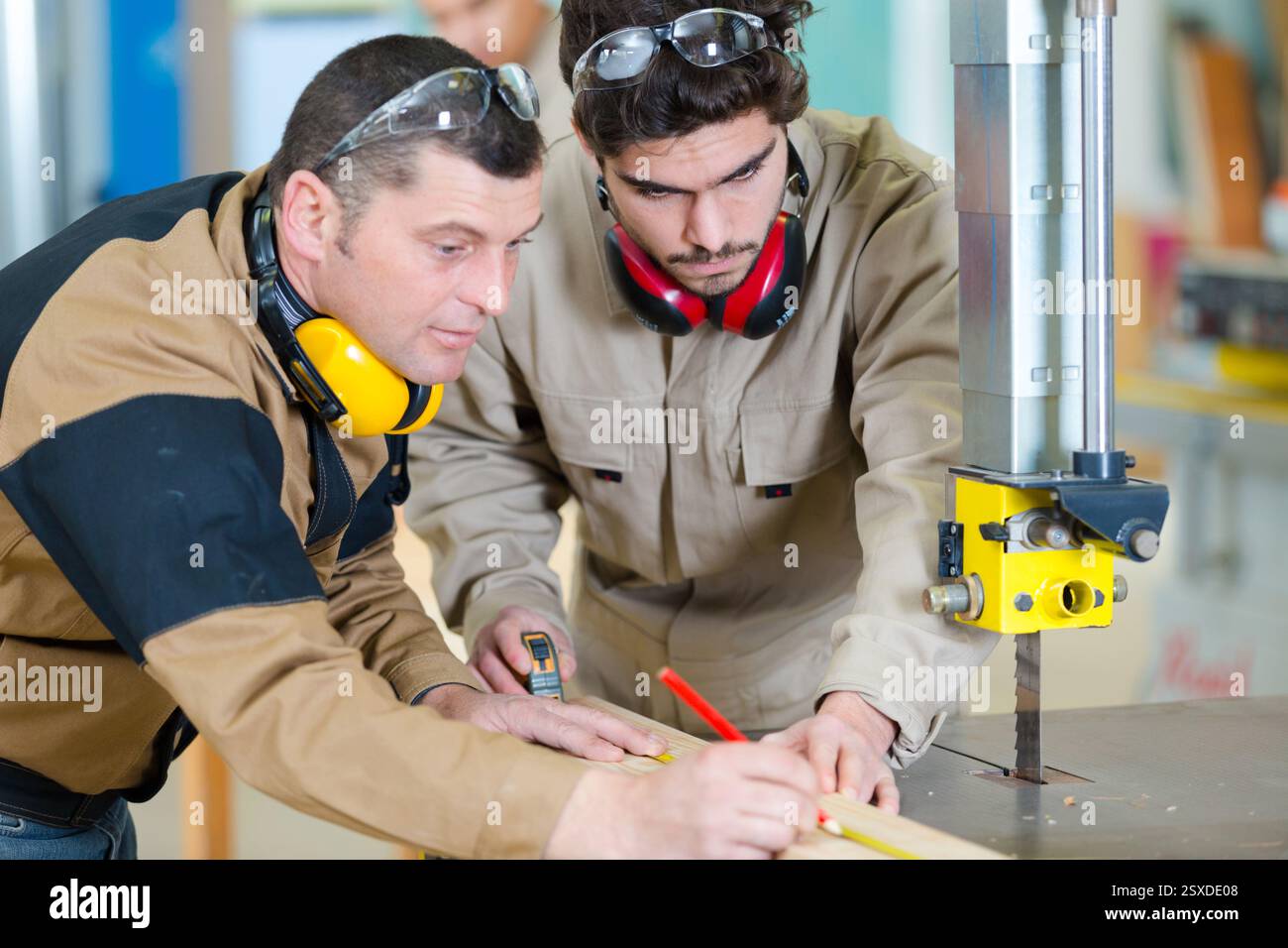 portrait of carpenter training younger man Stock Photo - Alamy