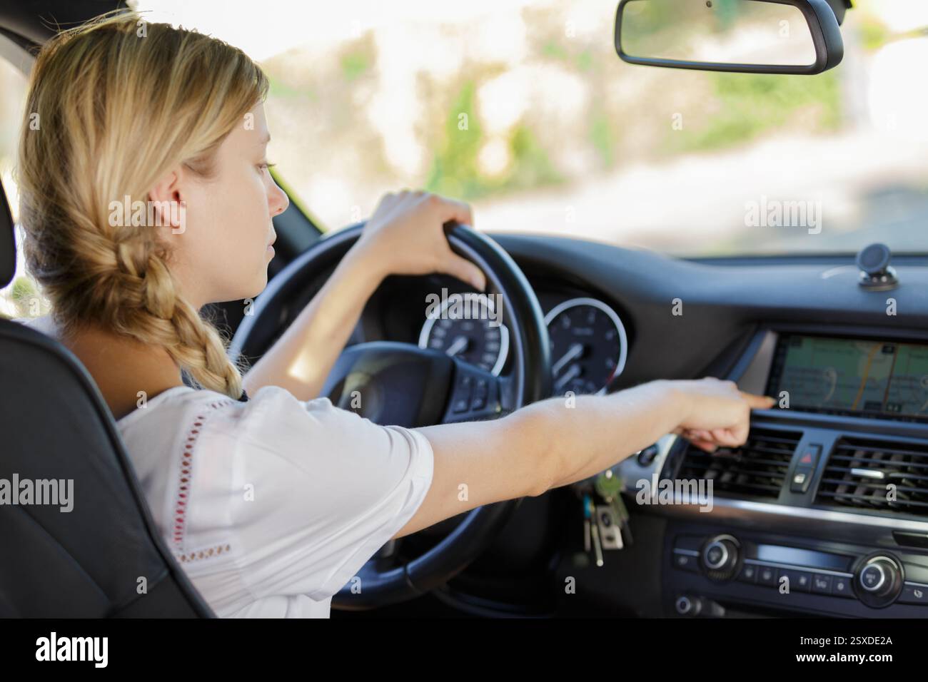 woman changing radio station in her car Stock Photo - Alamy