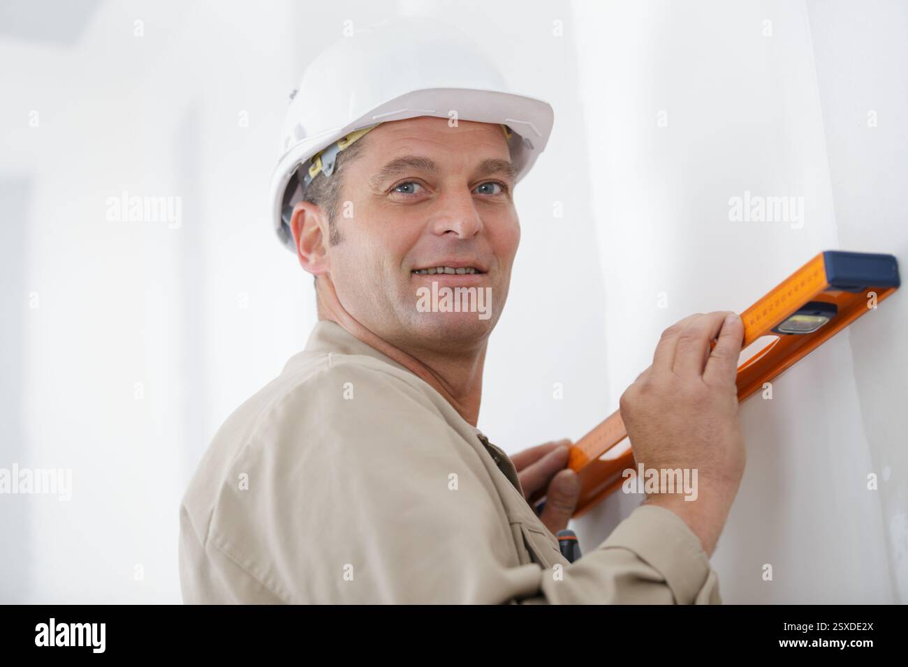 portrait of construction worker using spirit level Stock Photo - Alamy
