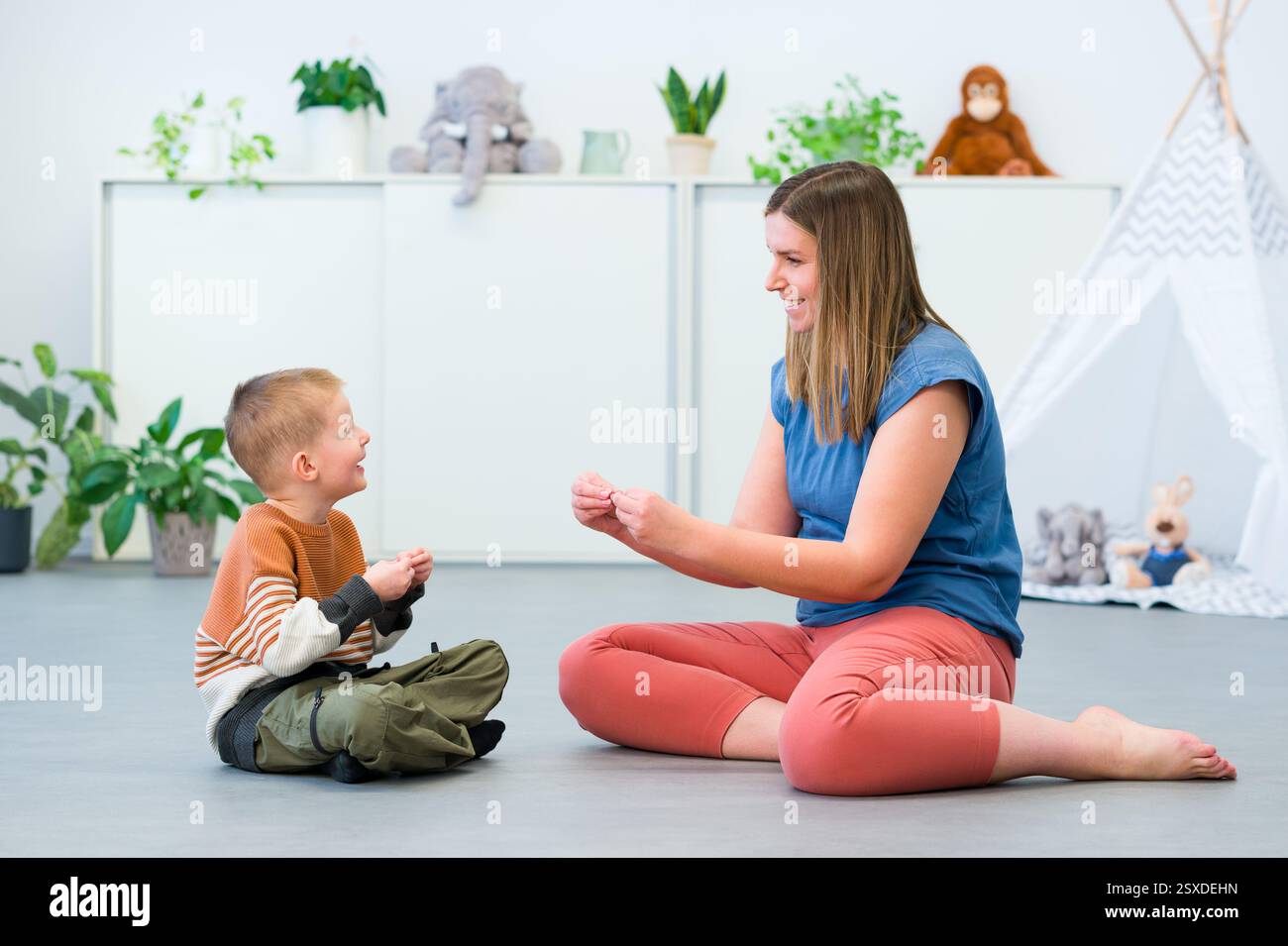 Baby Sign Language. Nonverbal child learning to sign with the help of a ...