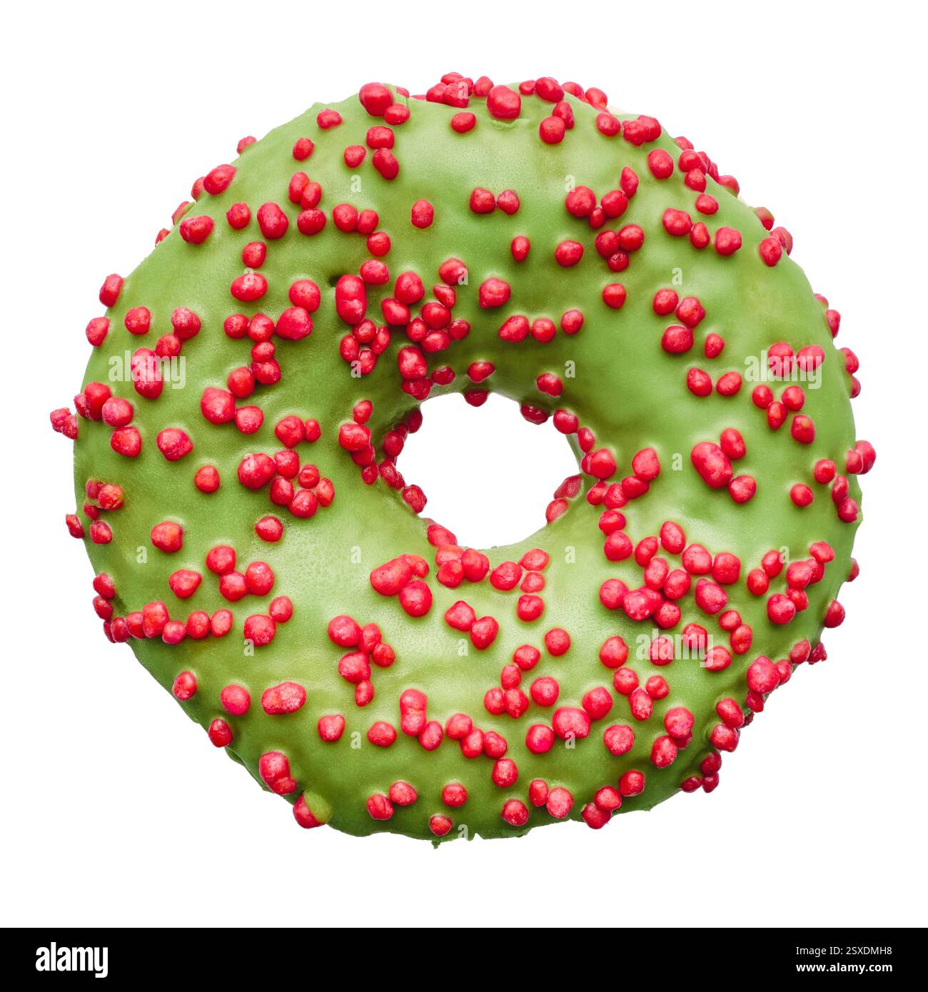 Single donut decorated with green icing and red sprinkles, close up shot, isolated on white ...