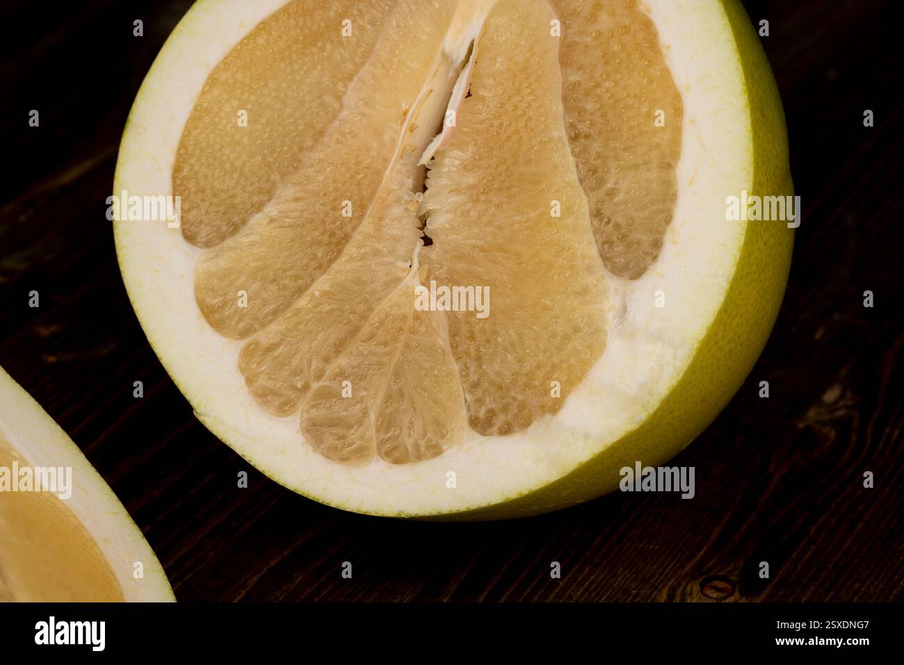 one pomelo with lots of pulp cut into pieces, huge juicy citrus closeup ...