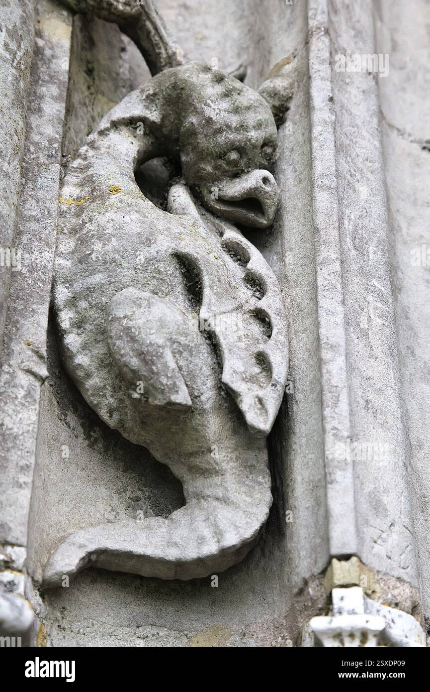 A grotesque dragon sculpture decorates a stone wall at Notre-Dame de ...