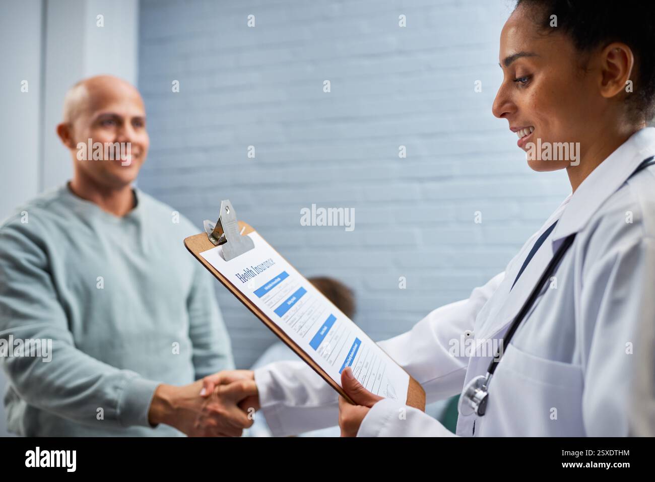 Doctor and Patient Handshake During a Medical Appointment in a ...
