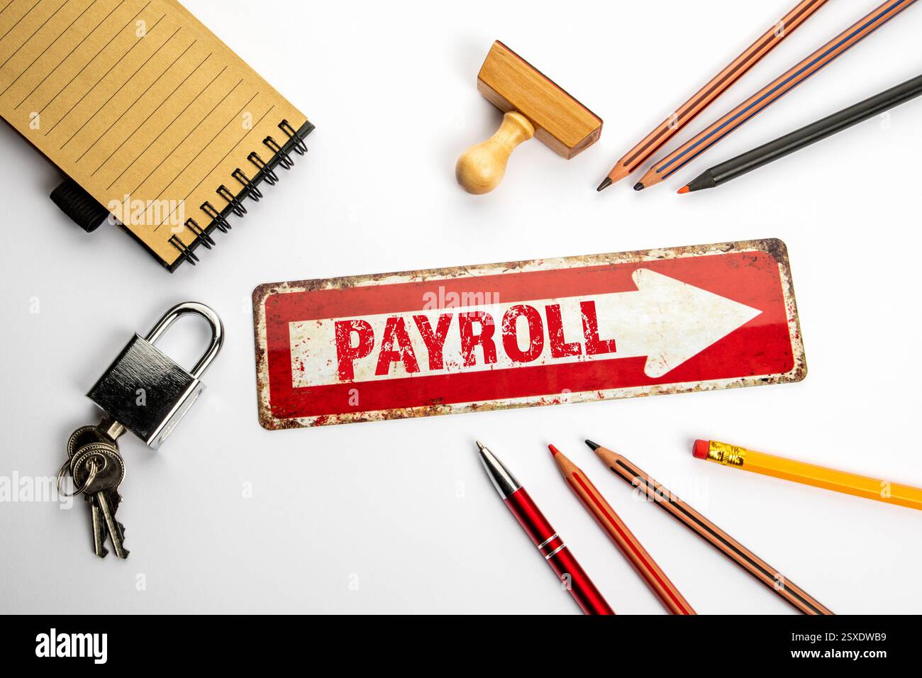 Payroll. Red direction arrow with text on white office desk Stock Photo ...