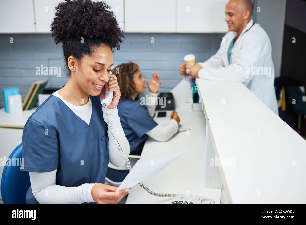 Medical Receptionists and Physician Collaborate in Busy Healthcare ...