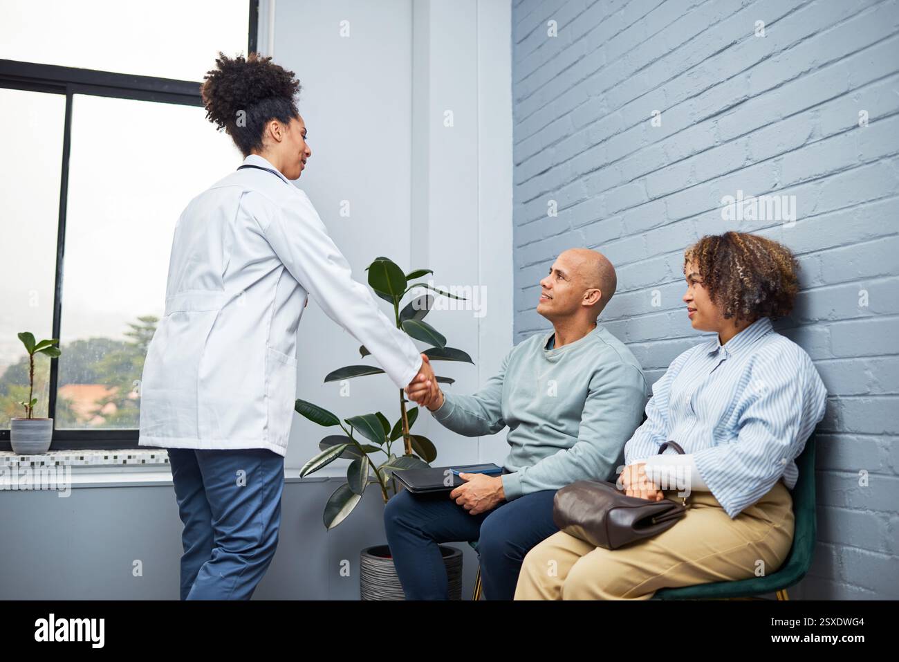 Healthcare Professional Meeting with Patients in a Modern Medical ...