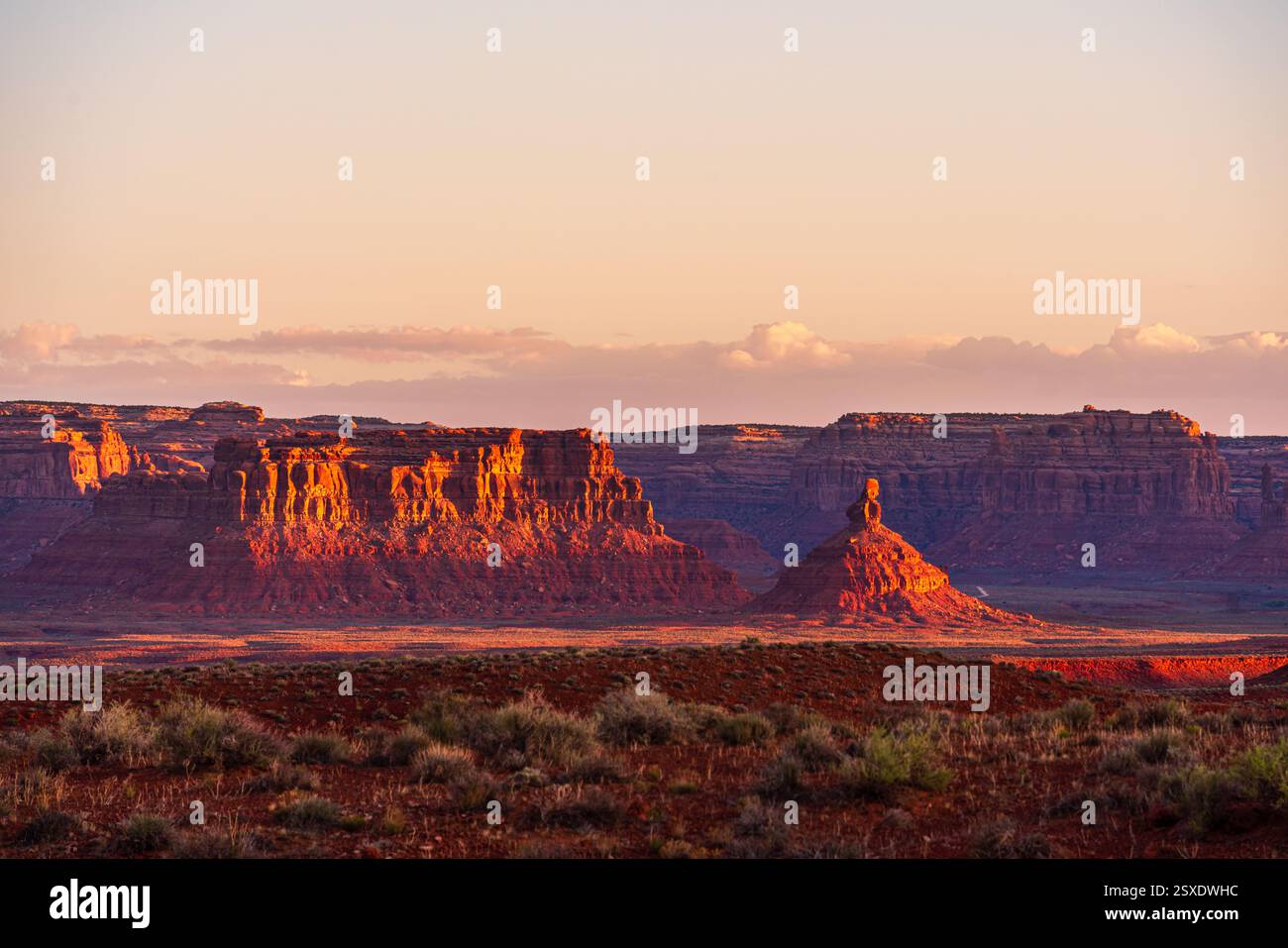 Sunrise light on sandstone valley with towering rock formations Stock ...