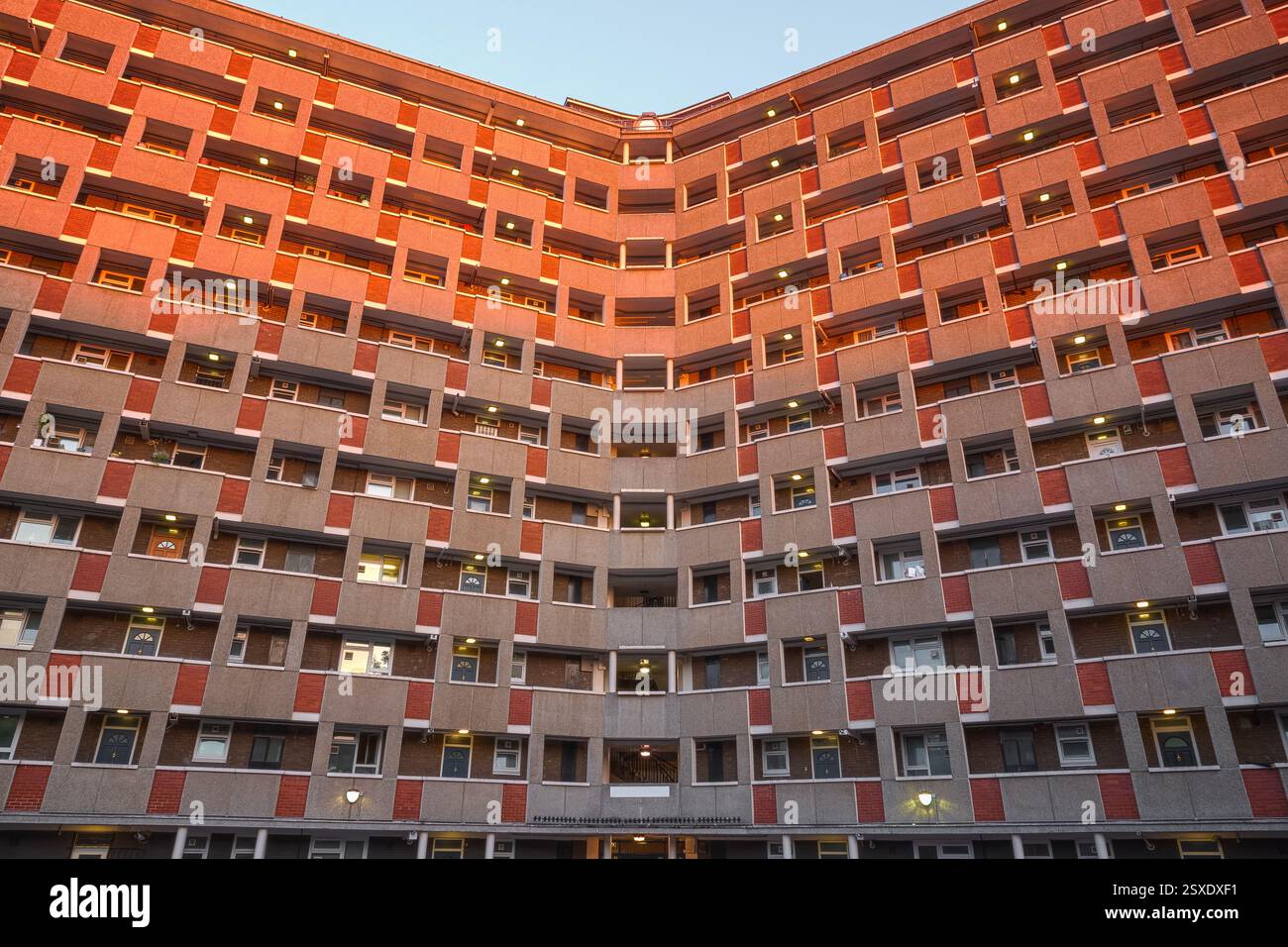 Sunset light casting shadow on the facade of the tower block George ...