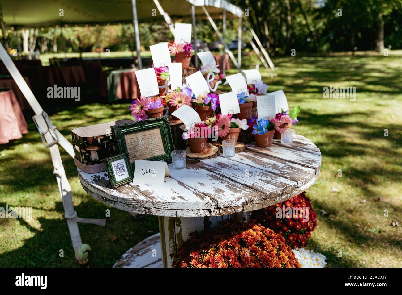 Whimsical garden backyard wedding table seating chart Stock Photo - Alamy