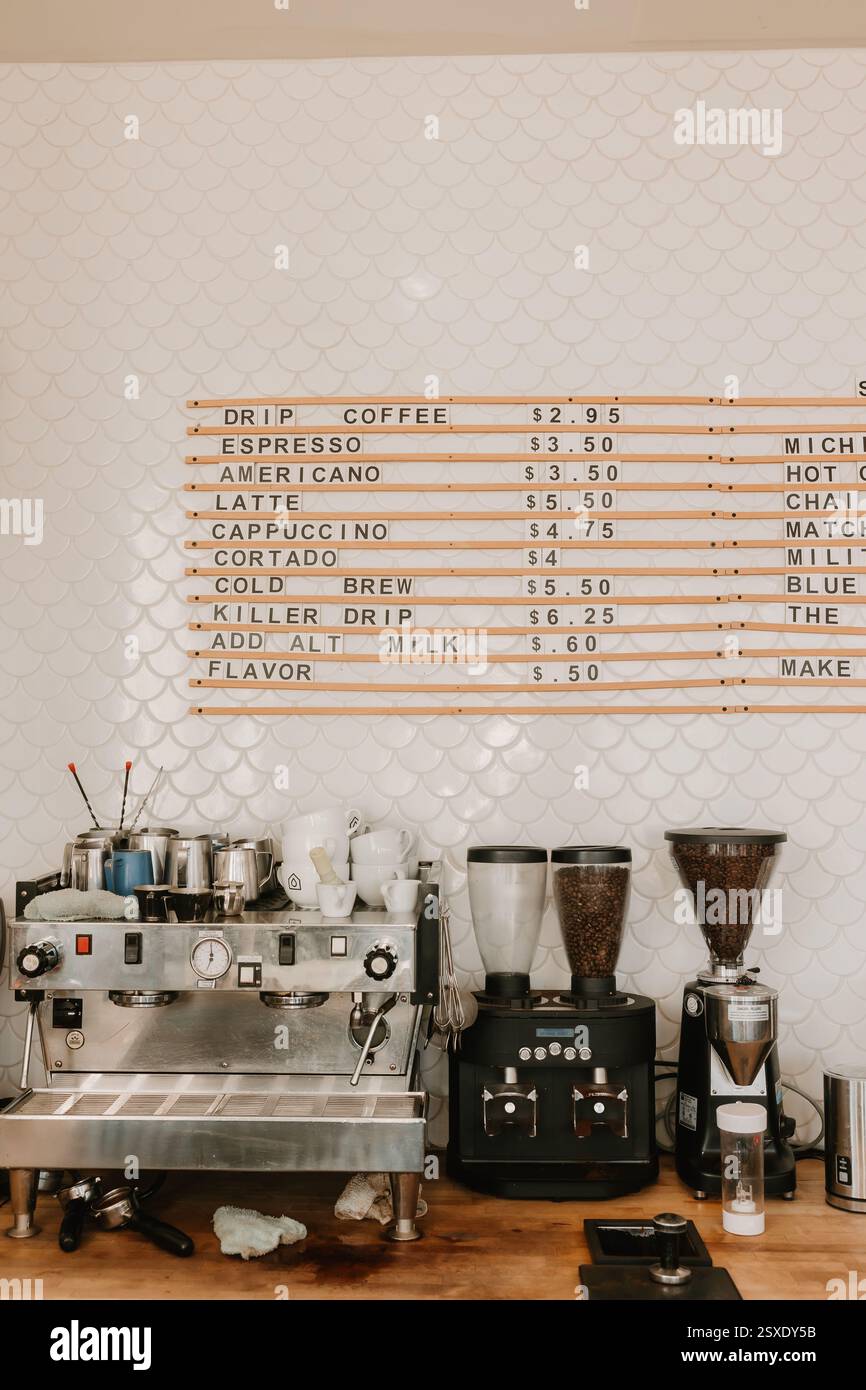 Coffee shop menu board above espresso machine and grinders Stock Photo ...