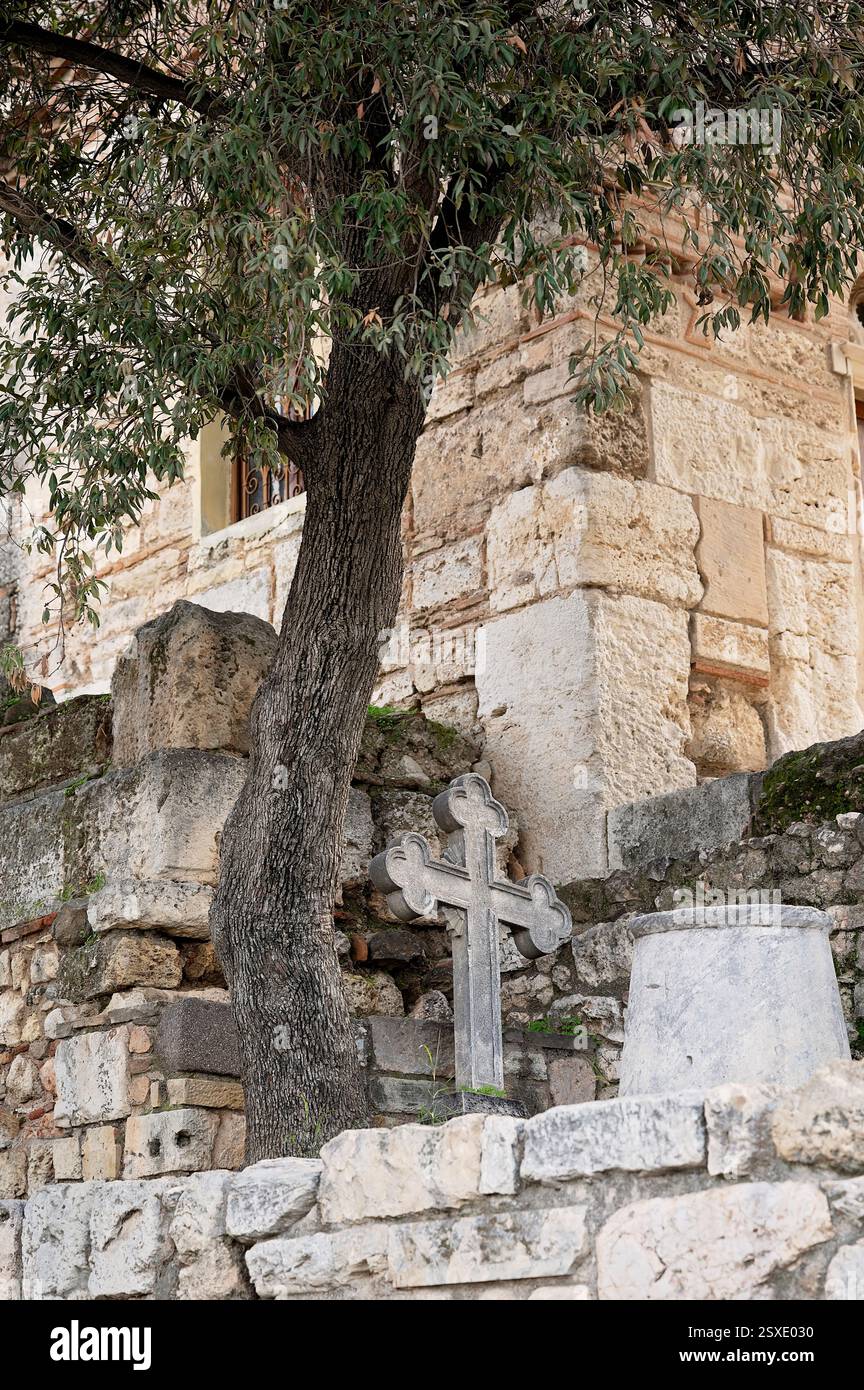 Stone cross and tree beside an ancient Byzantine church in Athens Stock ...