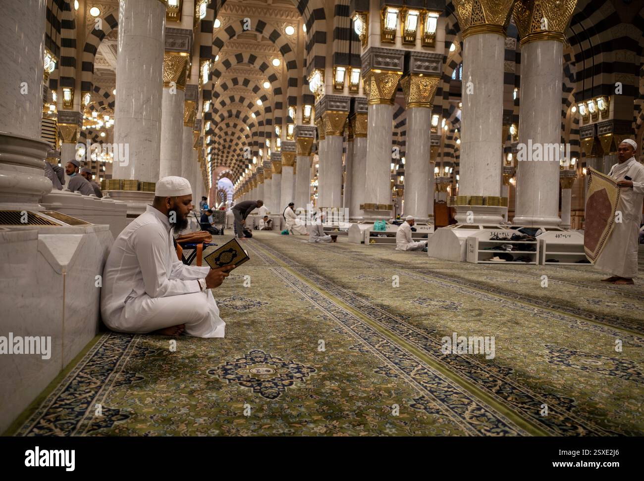 Medina, Saudi Arabia - July 3, 2024: Hajj pilgrims reading Quran in the ...