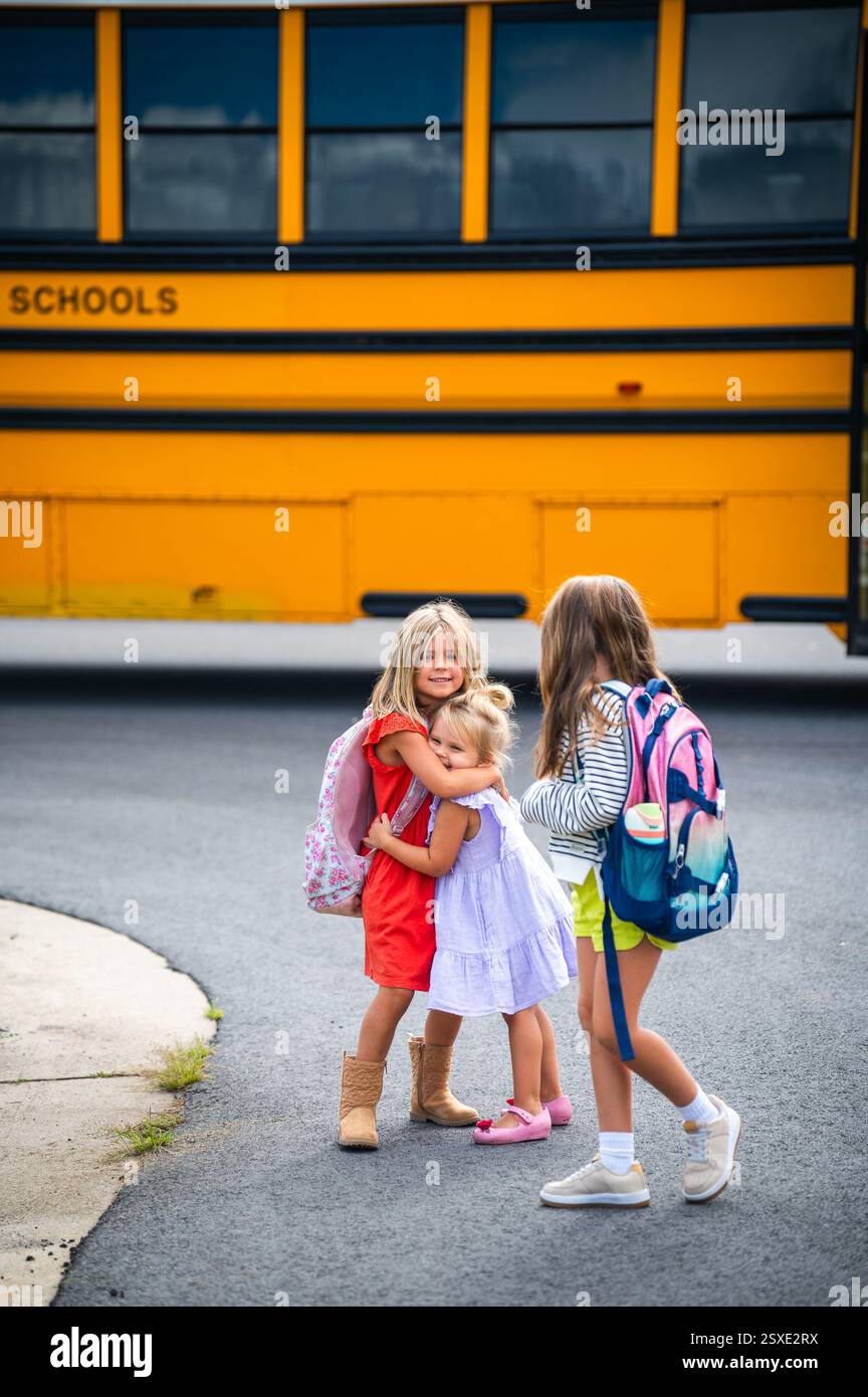 Kids Getting off School Bus to Hug Sisters Stock Photo - Alamy