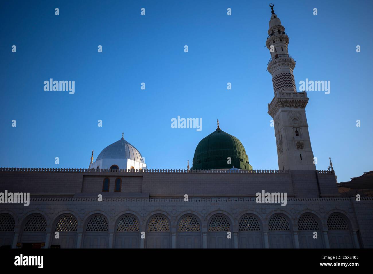 A green dome and minarets in Prophet Mosque in Madinah, also known as ...