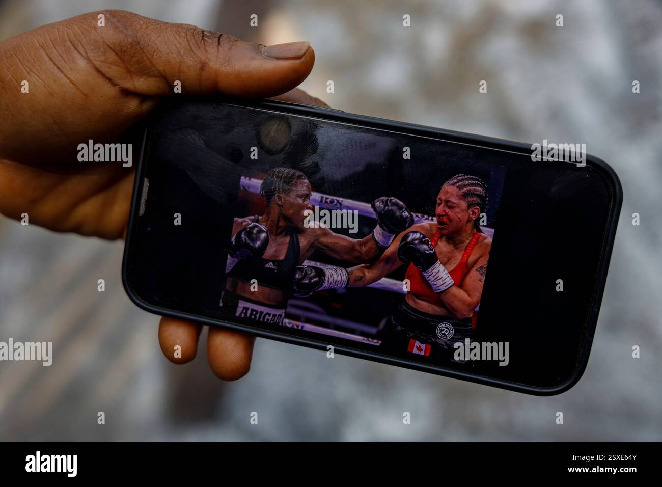 Abigail Kwartekaa Quartey, 28, shows a photo of her match against Sangeeta Birdie from Britain ...