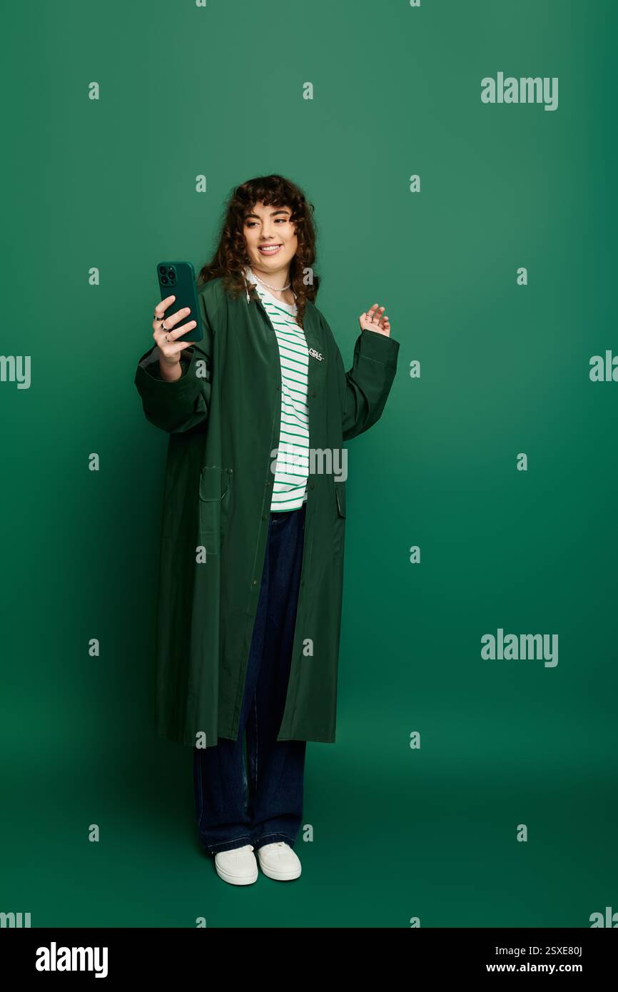 Emotional and fashionable young woman enjoys a moment while capturing a ...