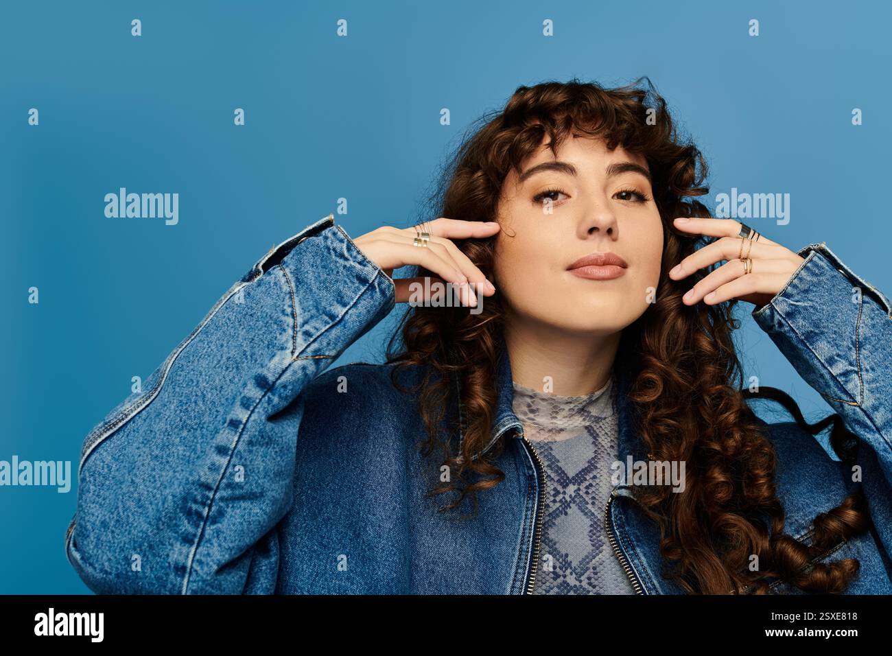 A stylish young woman expresses emotions through her bold pose and ...