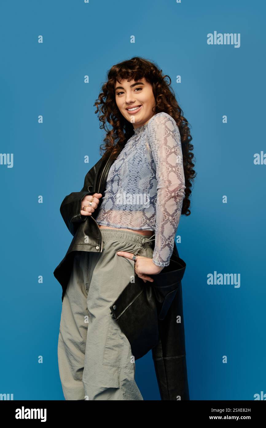 A stylish young woman shows her emotions with a pose, highlighting her ...