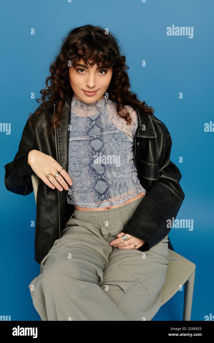 Stylish young woman poses with elegance, showcasing her trendy outfit ...