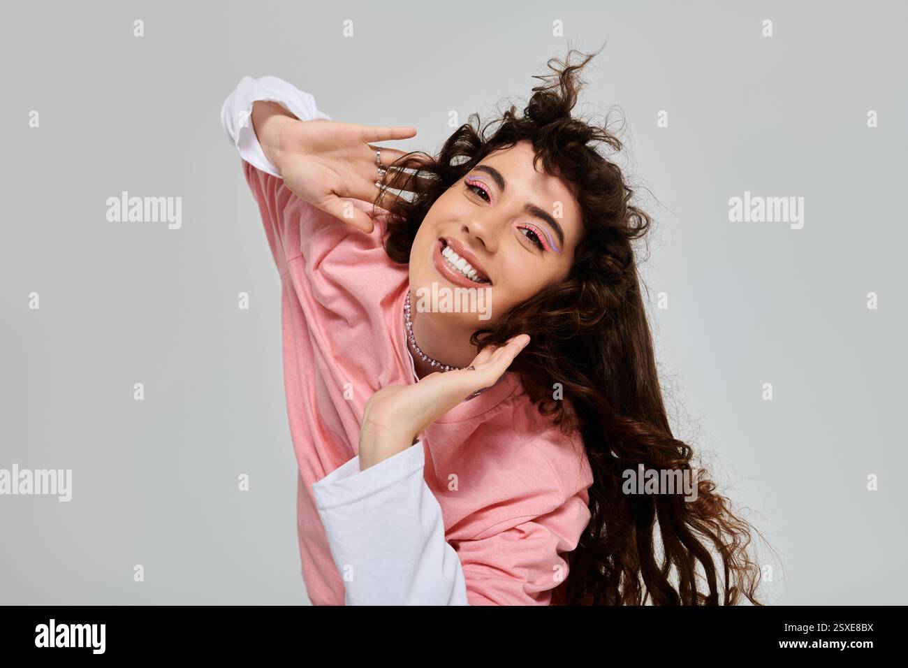 Stylish young woman radiates joy and confidence with playful poses and ...