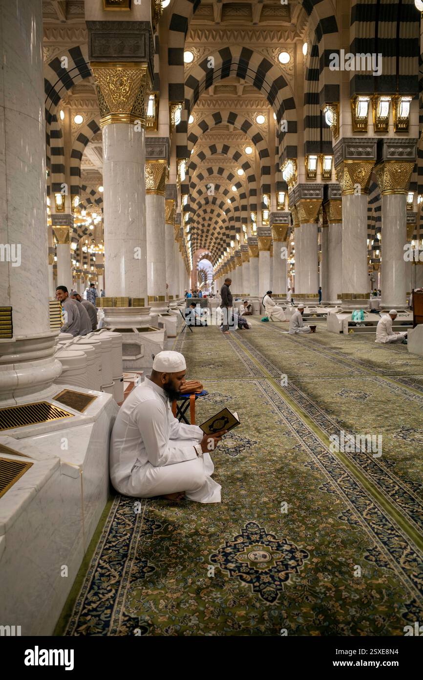 Medina, Saudi Arabia - July 3, 2024: Hajj pilgrims reading Quran in the ...