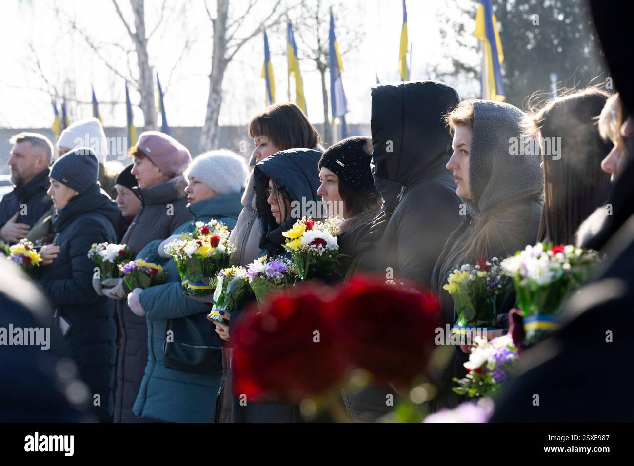 Bucha, Ukraine. 24th Feb, 2025. People gather for a ceremony on the 3rd ...