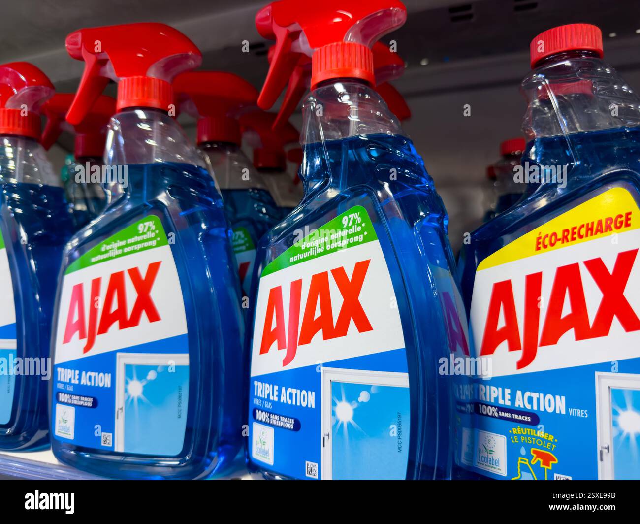 Bright blue cleaning products lined up on supermarket shelves for ...