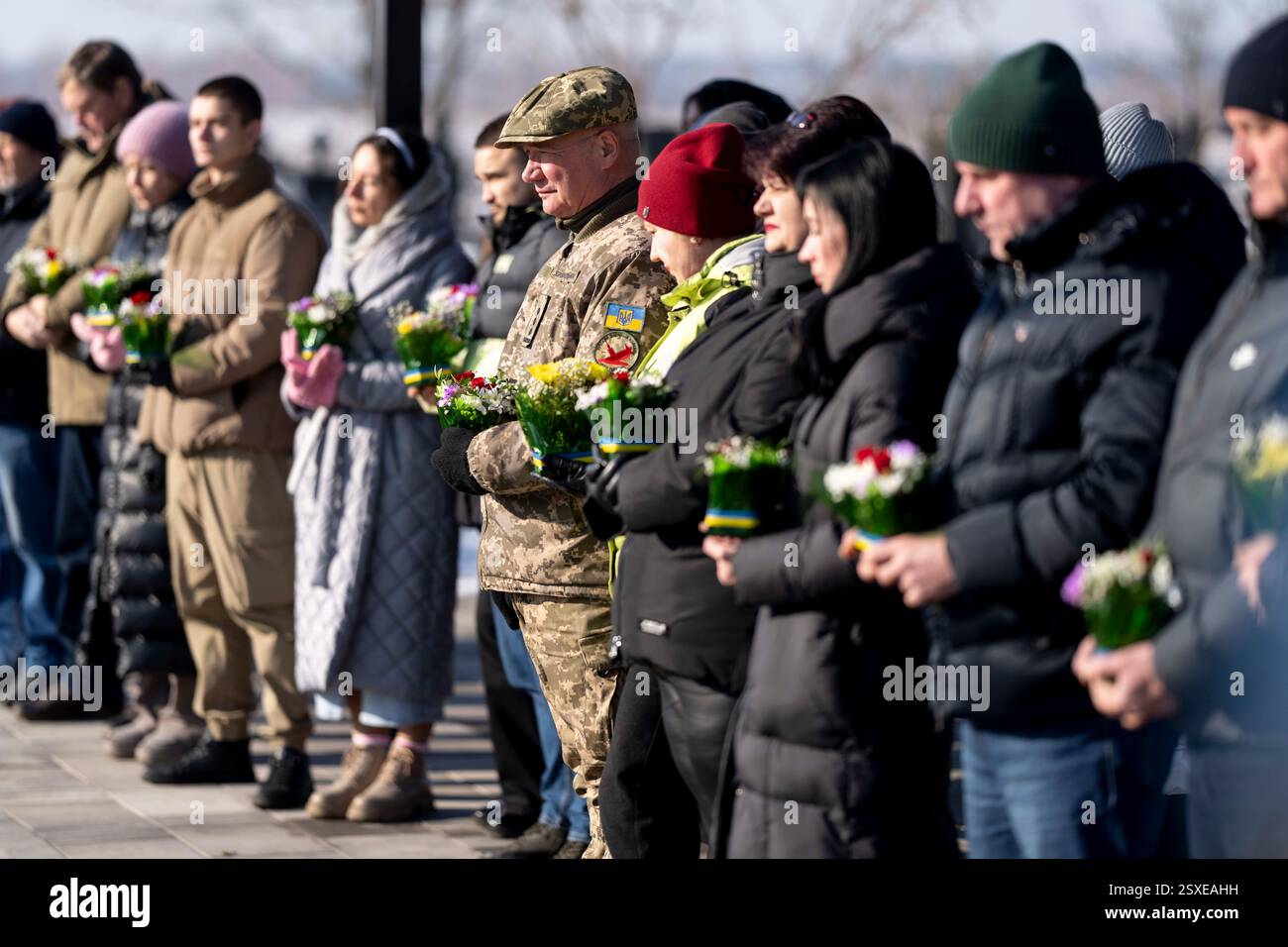 February 24, 2025, Bucha, Kyiv Region, Ukraine: People gather for a ...