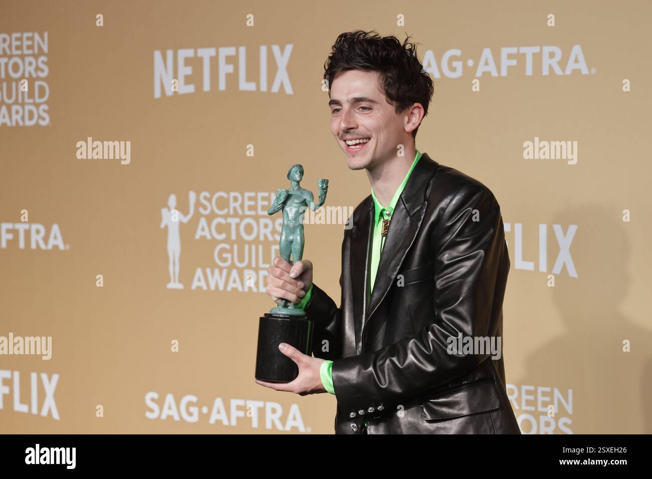 Timothée Chalamet poses in the press room with the award for ...