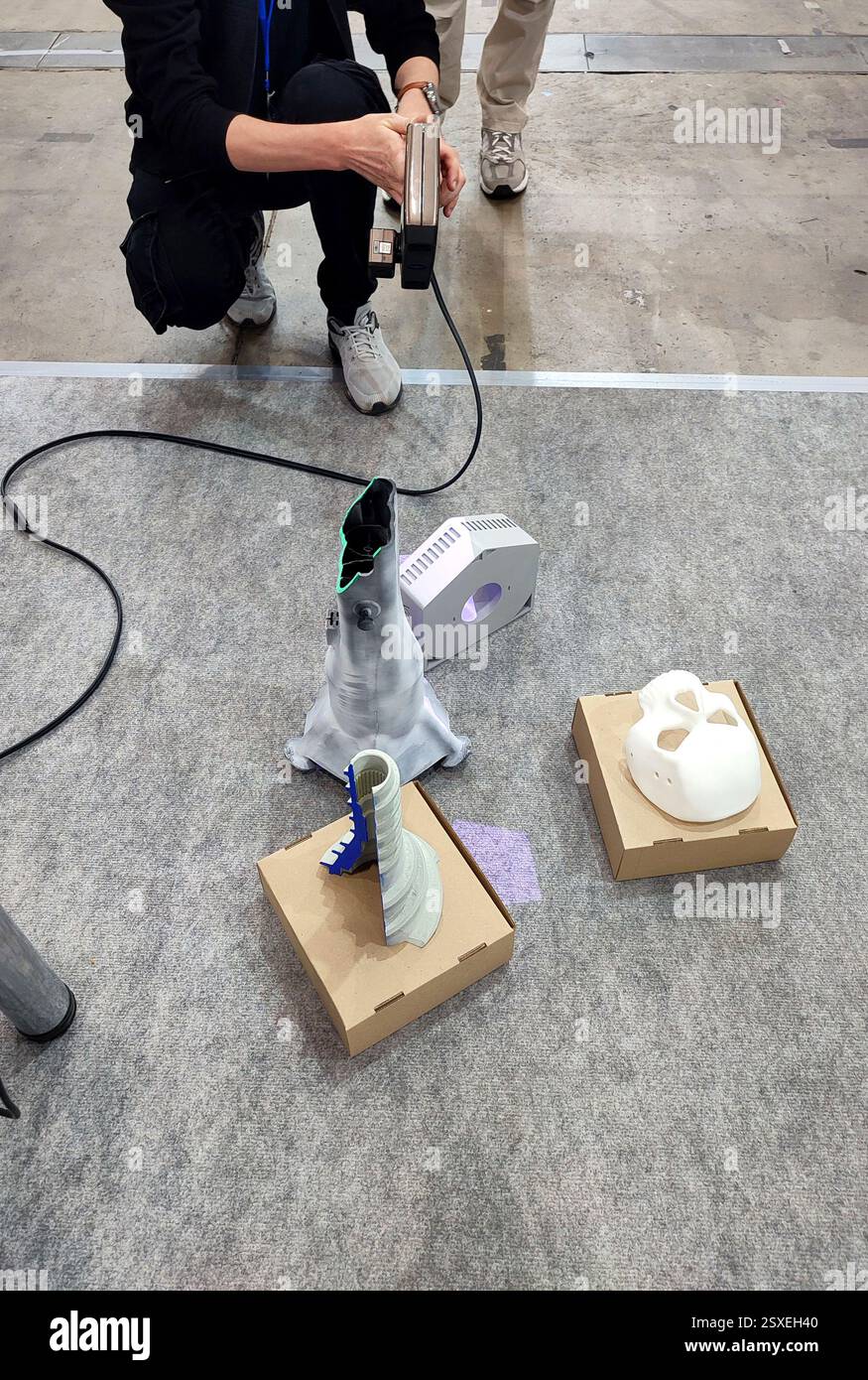 3D scanning. Working portable 3D scanner. Man scanning an object with a ...