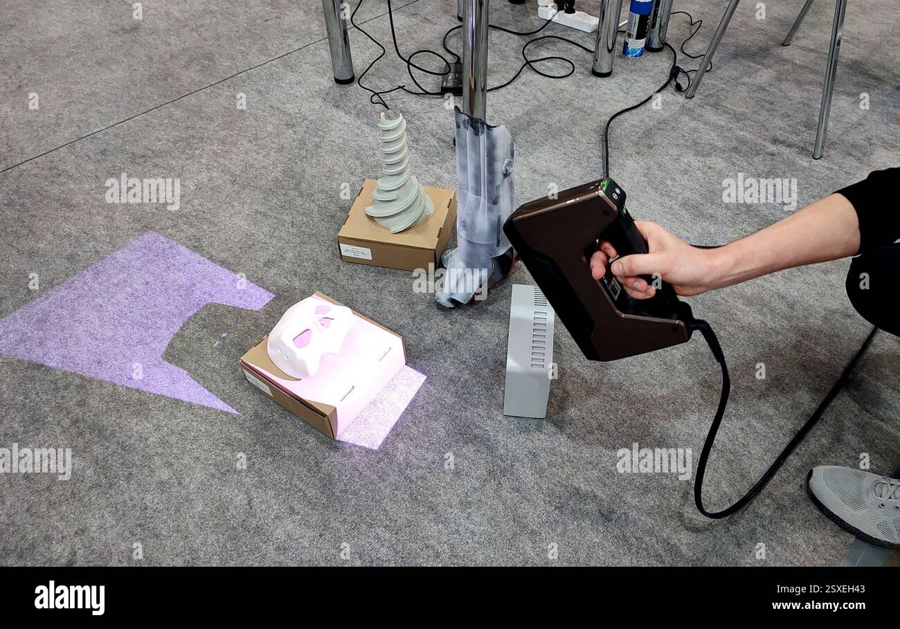 3D scanning. Working portable 3D scanner. Man scanning an object with a ...