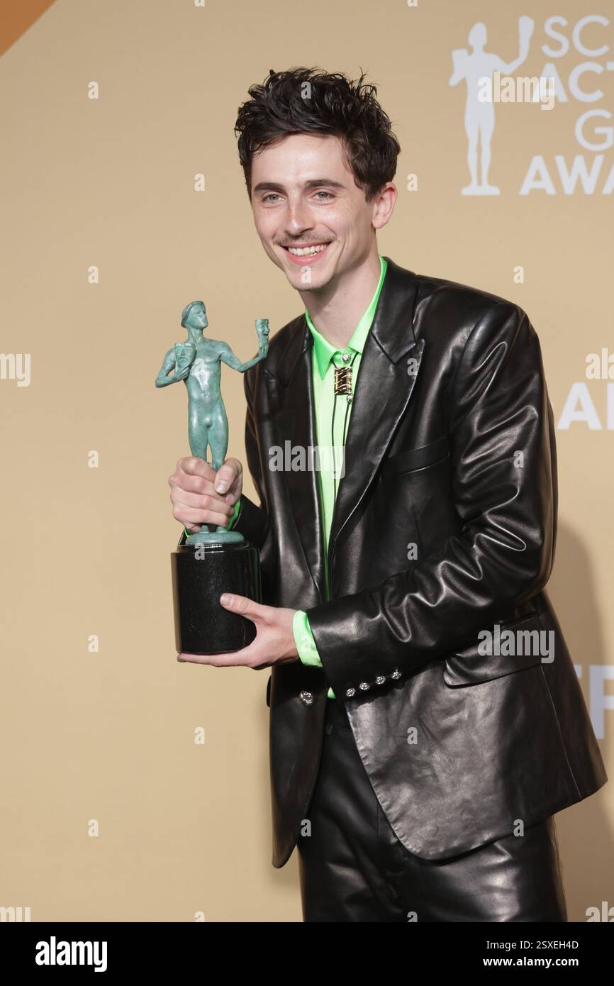 Timothée Chalamet poses in the press room with the award for ...