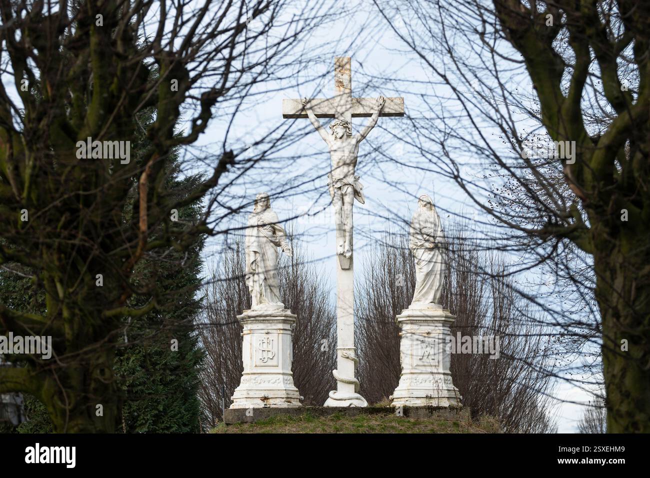 Statue of Jesus at the cross of Golgotha with Mary and Mary Magdalene ...