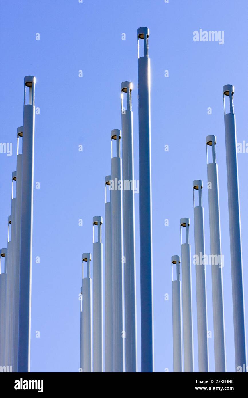 Row of tall, white poles with lights on top. The poles are arranged in ...