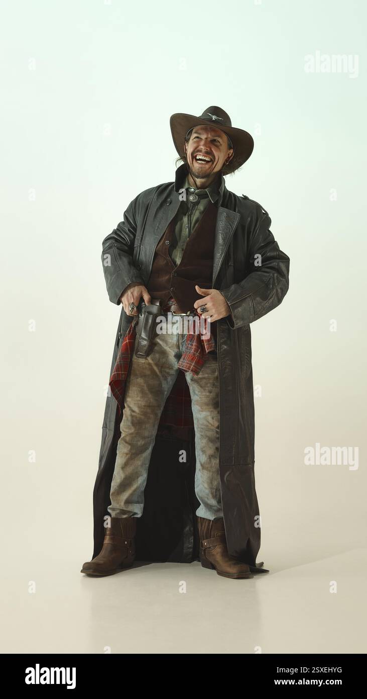 Portrait of cheerful man, cowboy with wide smile, wearing long coat ...