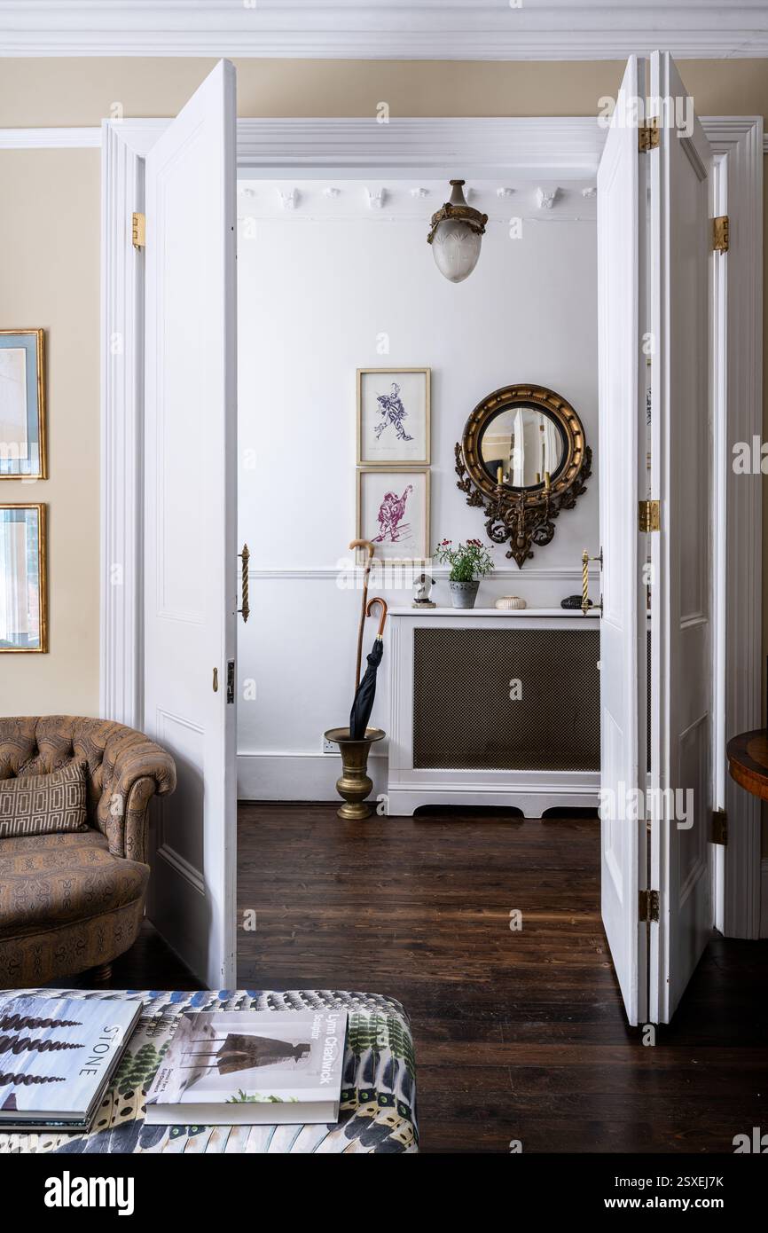 Concertina door with vintage mirror in hallway and ottoman in Christian ...