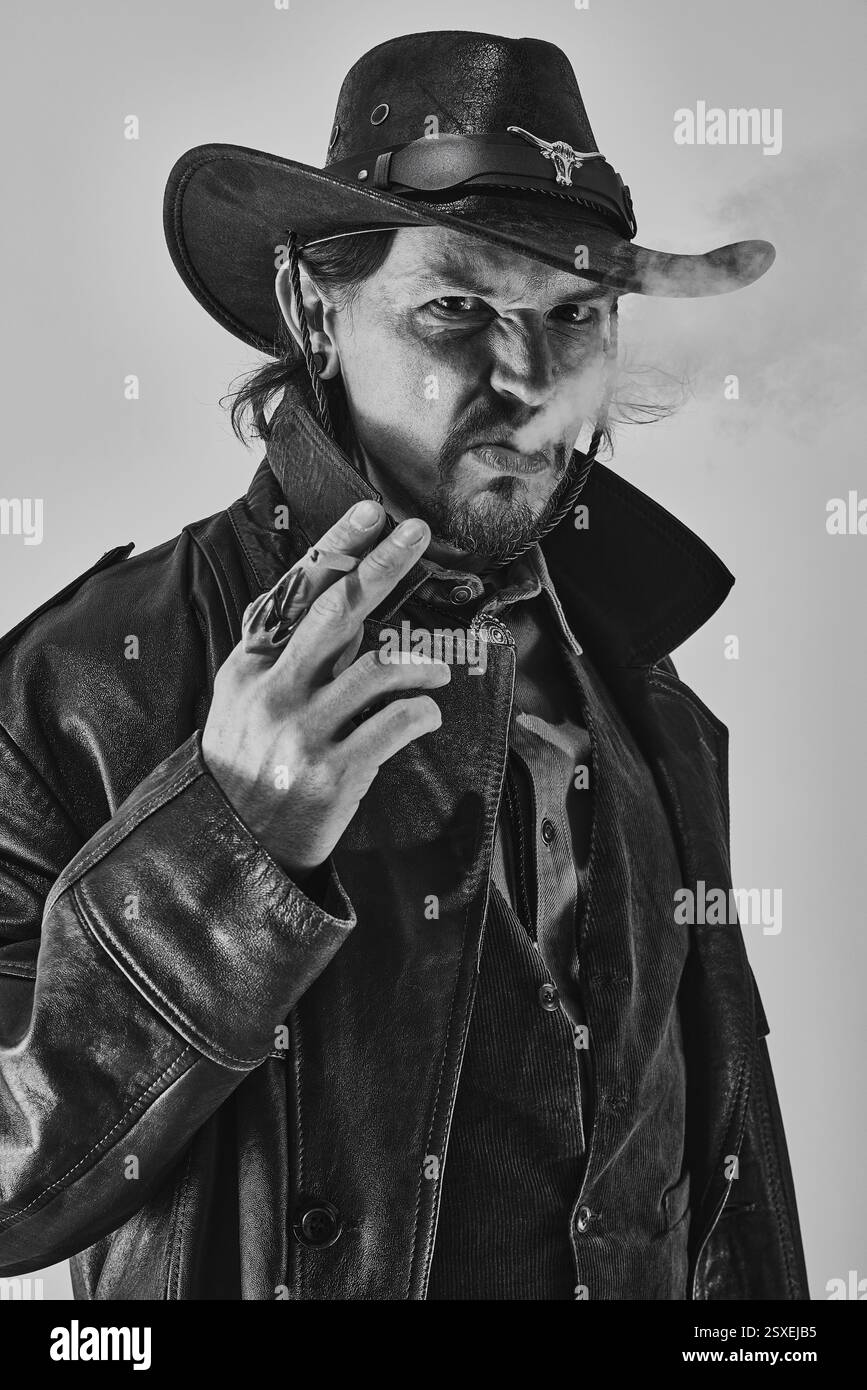 Black and white portrait of man, cowboy with intense gaze smoking ...