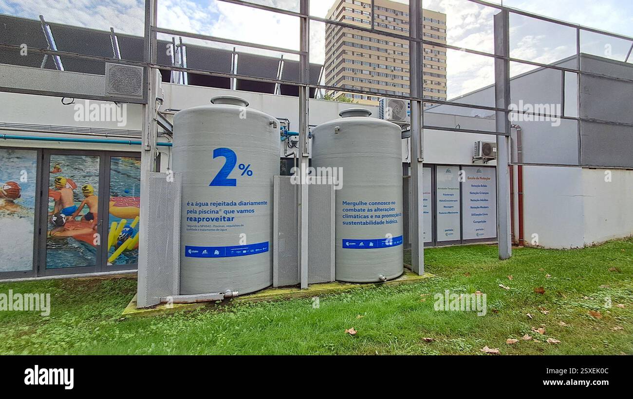 Two large water tanks stand outside a public pool, promoting water ...