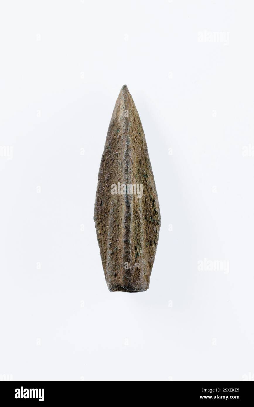 This arrow point, crafted from bronze or copper alloy, dates back to ...