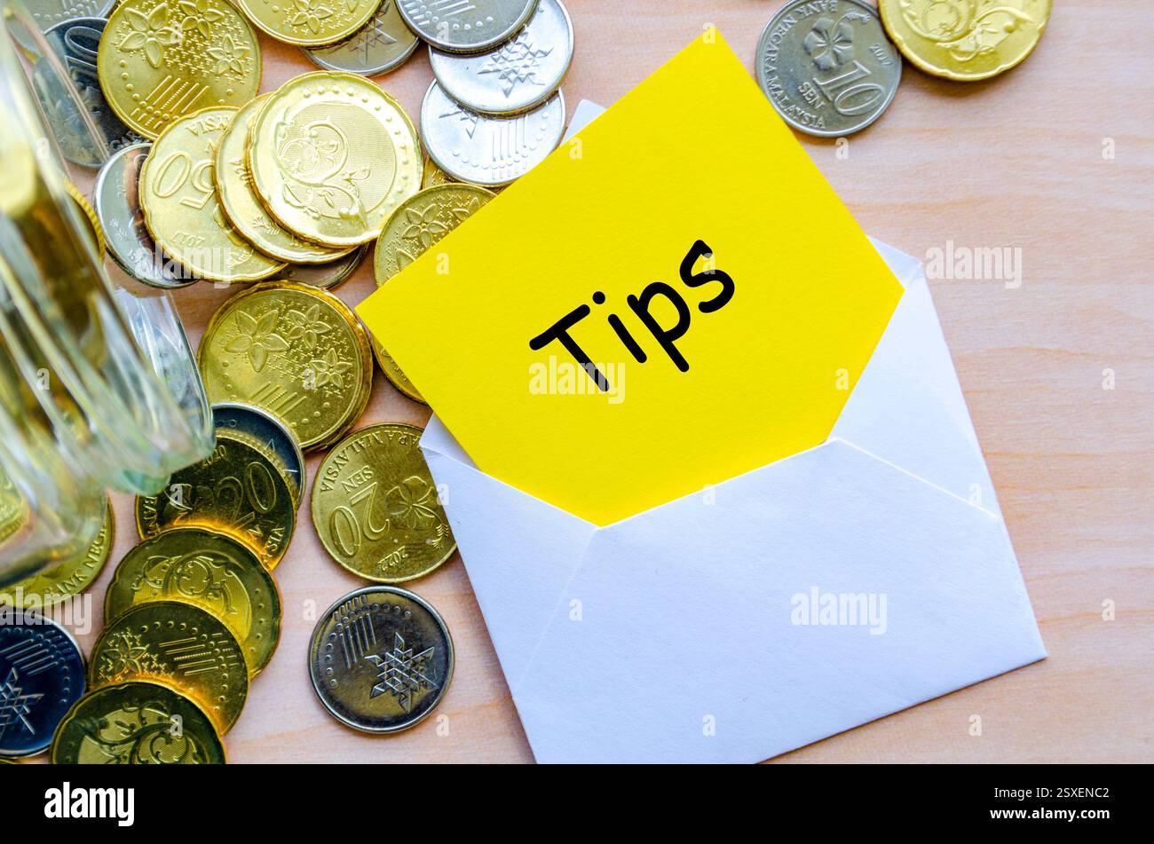 Tips text on yellow paper covered with white envelope Stock Photo - Alamy