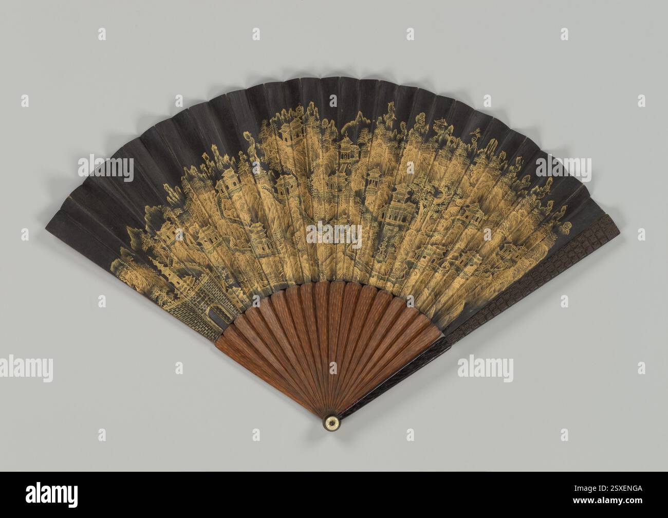 A 19th-century folding fan from China, featuring paper and wood ...